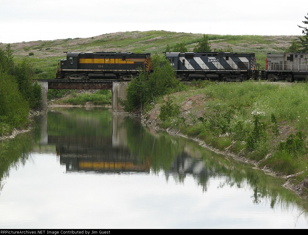 LSRC 281 leads train 325 across the LaFarge quarry drainage river.